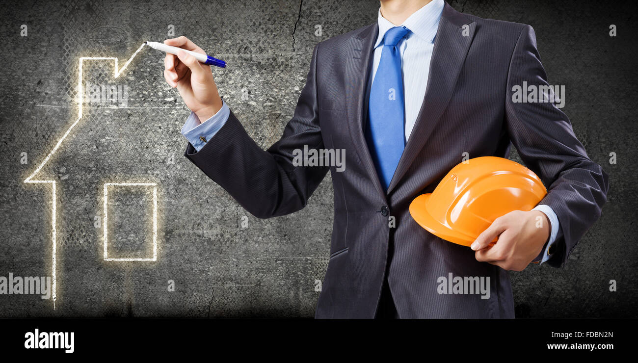 Young man engineer drawing sketches of construction project Stock Photo ...