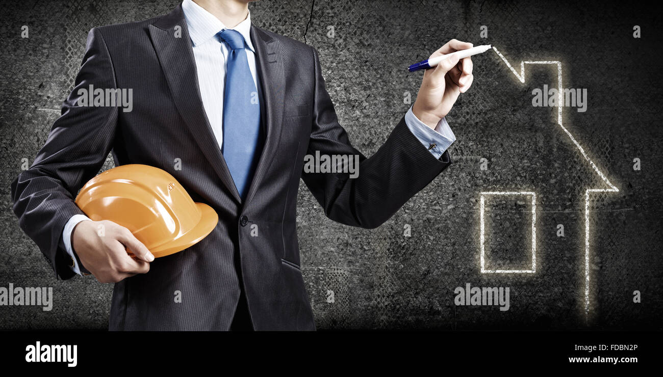 Young man engineer drawing sketches of construction project Stock Photo ...