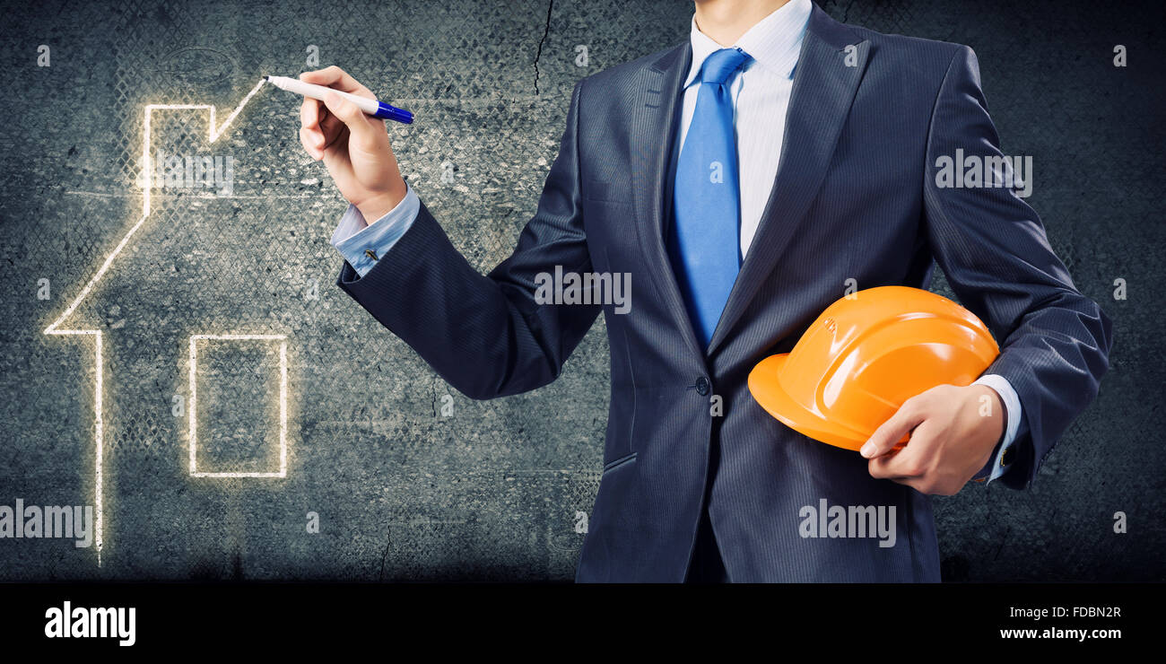 Young man engineer drawing sketches of construction project Stock Photo ...