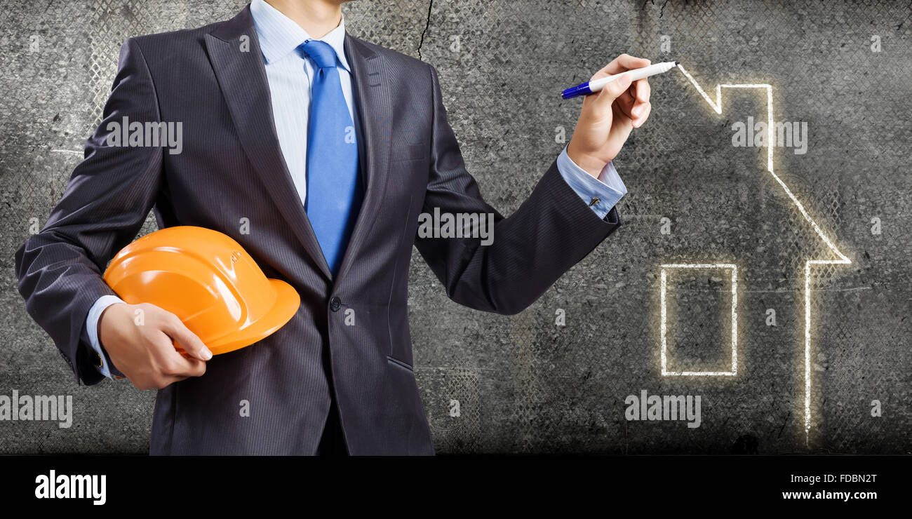 Young man engineer drawing sketches of construction project Stock Photo ...