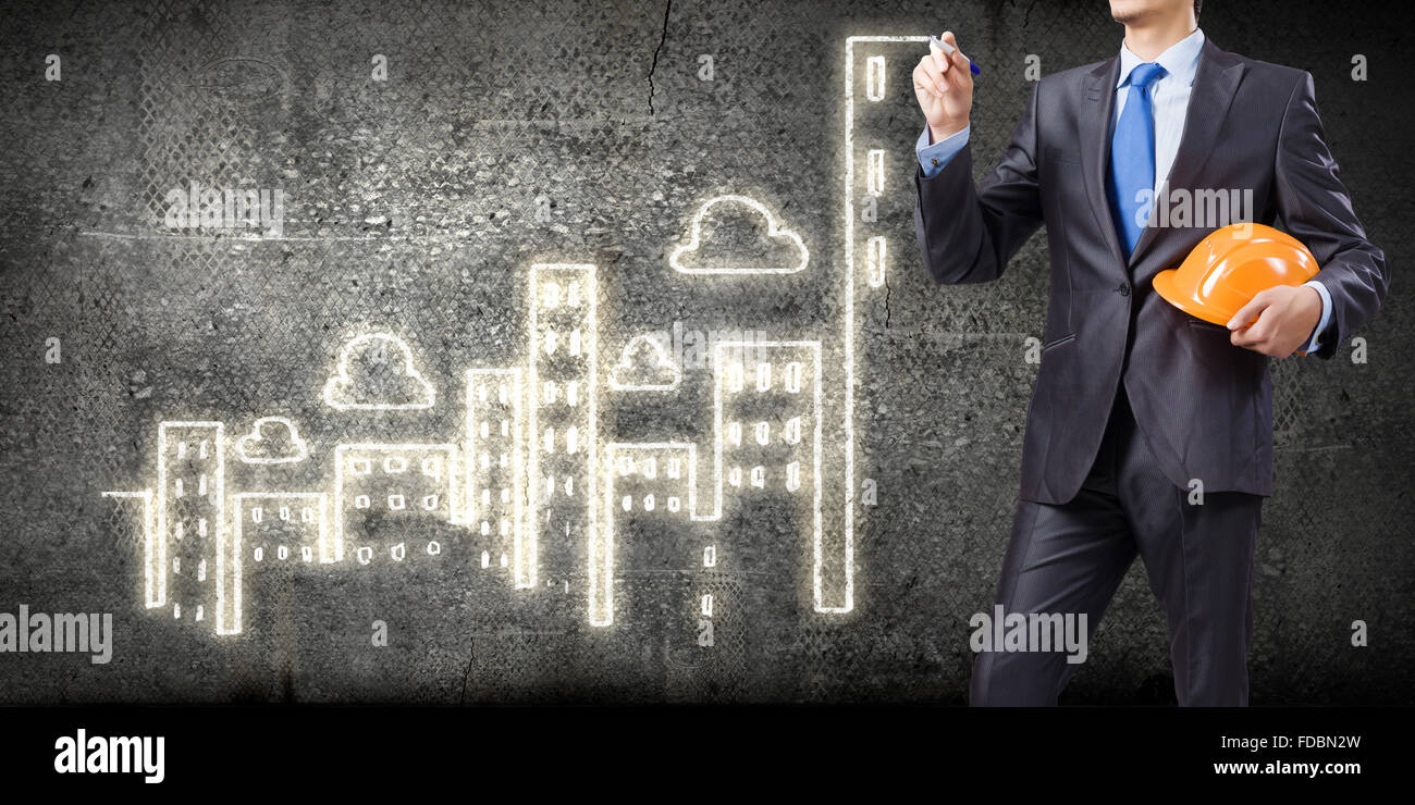 Young man engineer drawing sketches of construction project Stock Photo ...