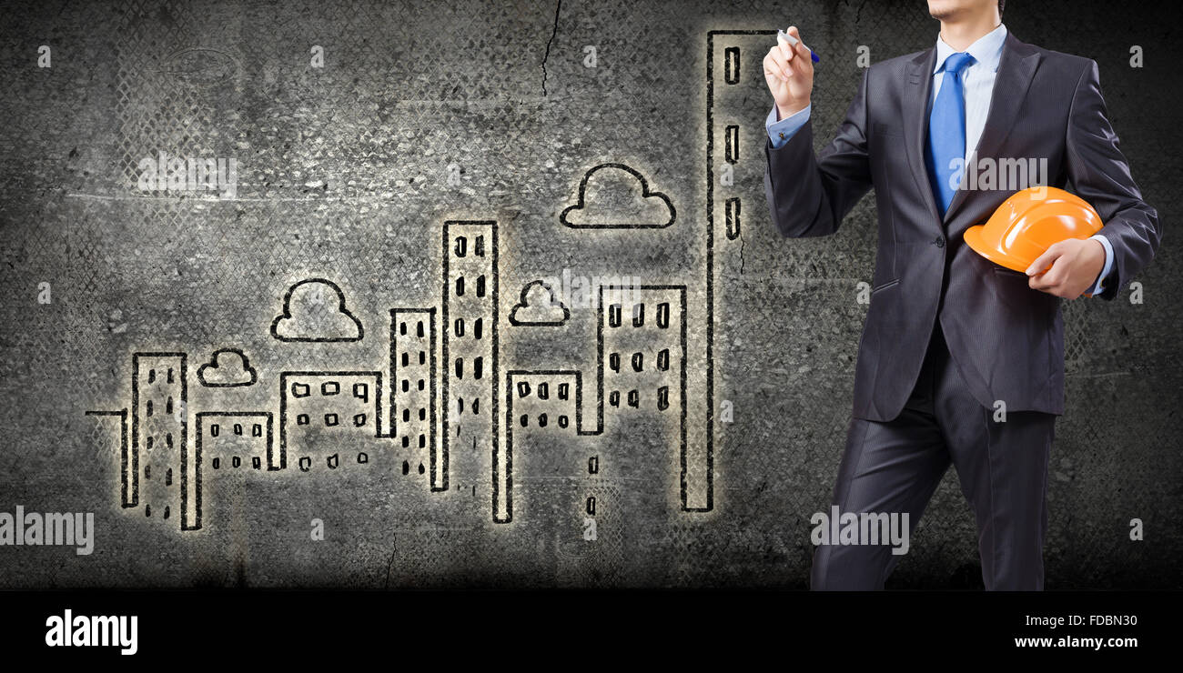 Young man engineer drawing sketches of construction project Stock Photo ...