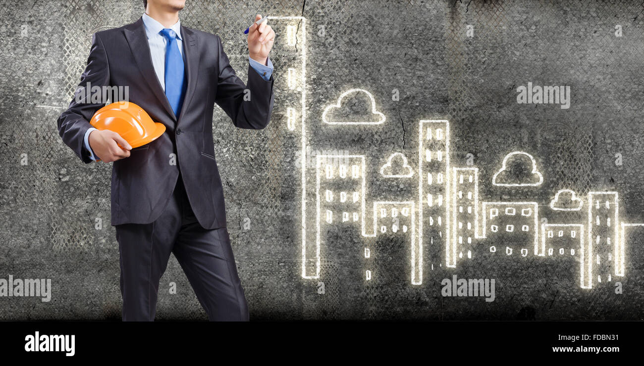 Young man engineer drawing sketches of construction project Stock Photo ...