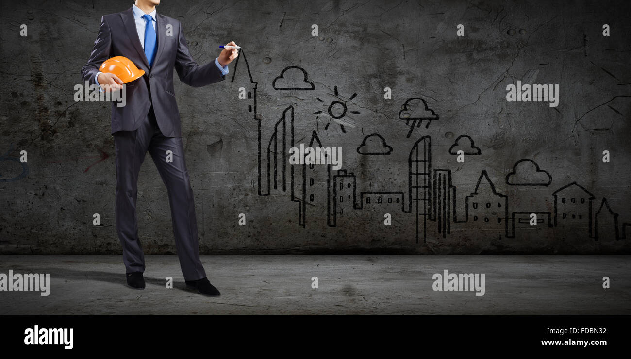 Young man engineer drawing sketches of construction project Stock Photo ...