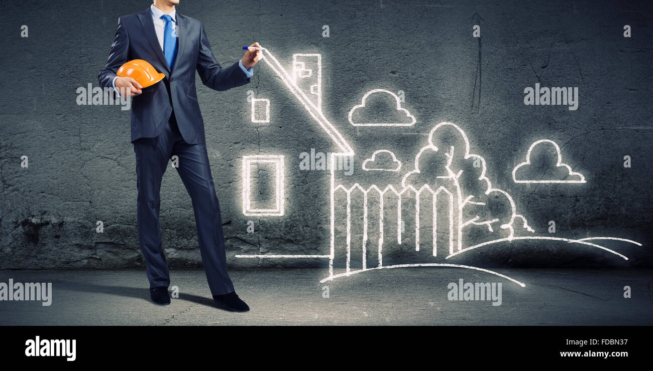 Young man engineer drawing sketches of construction project Stock Photo ...