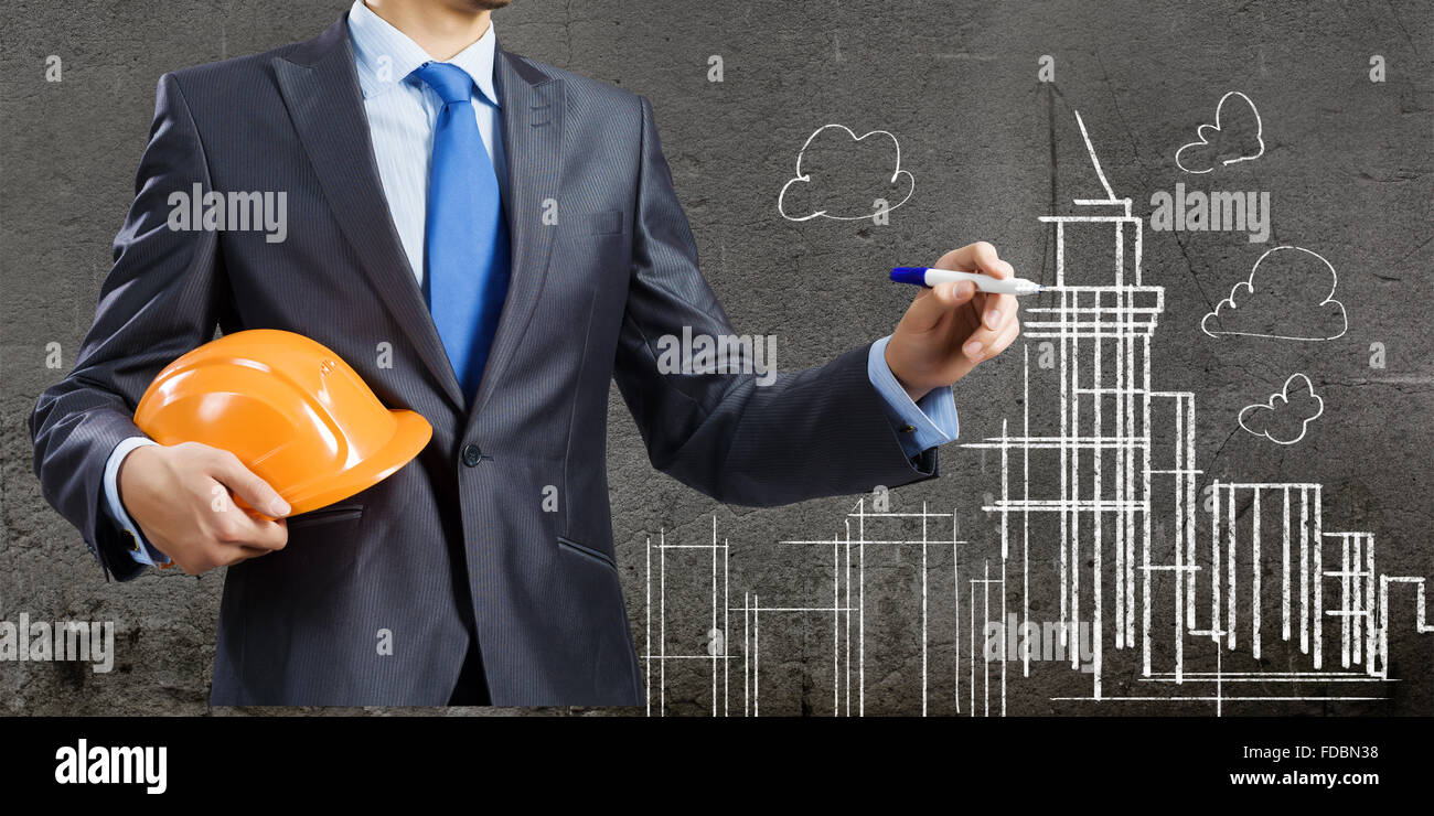 Young man engineer drawing sketches of construction project Stock Photo ...