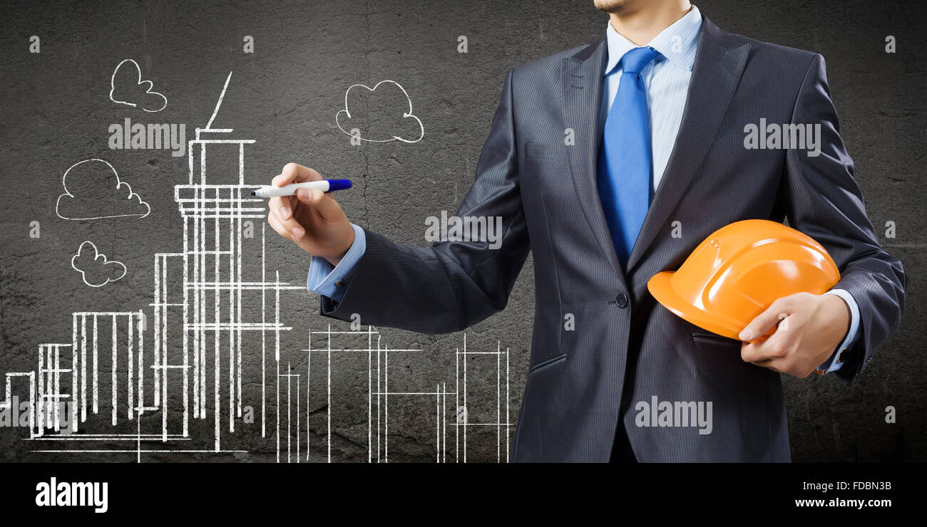 Young man engineer drawing sketches of construction project Stock Photo ...