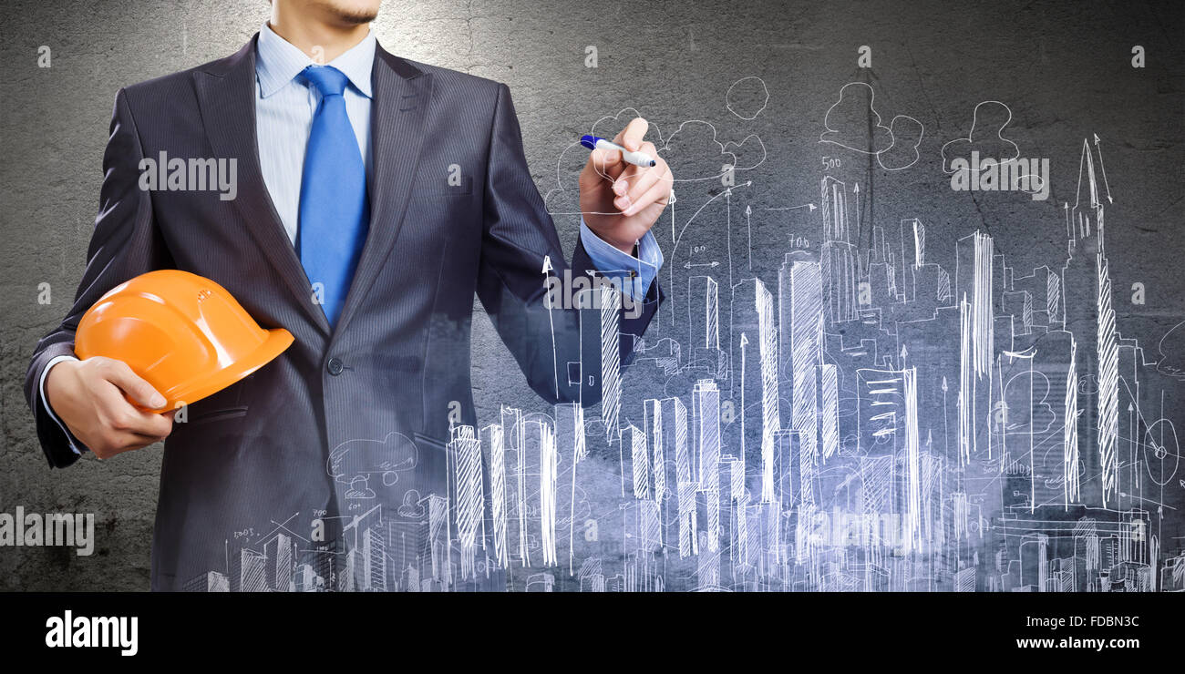 Young man engineer drawing sketches of construction project Stock Photo ...