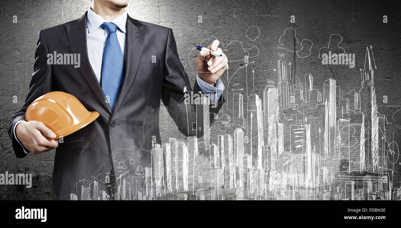 Young man engineer drawing sketches of construction project Stock Photo ...