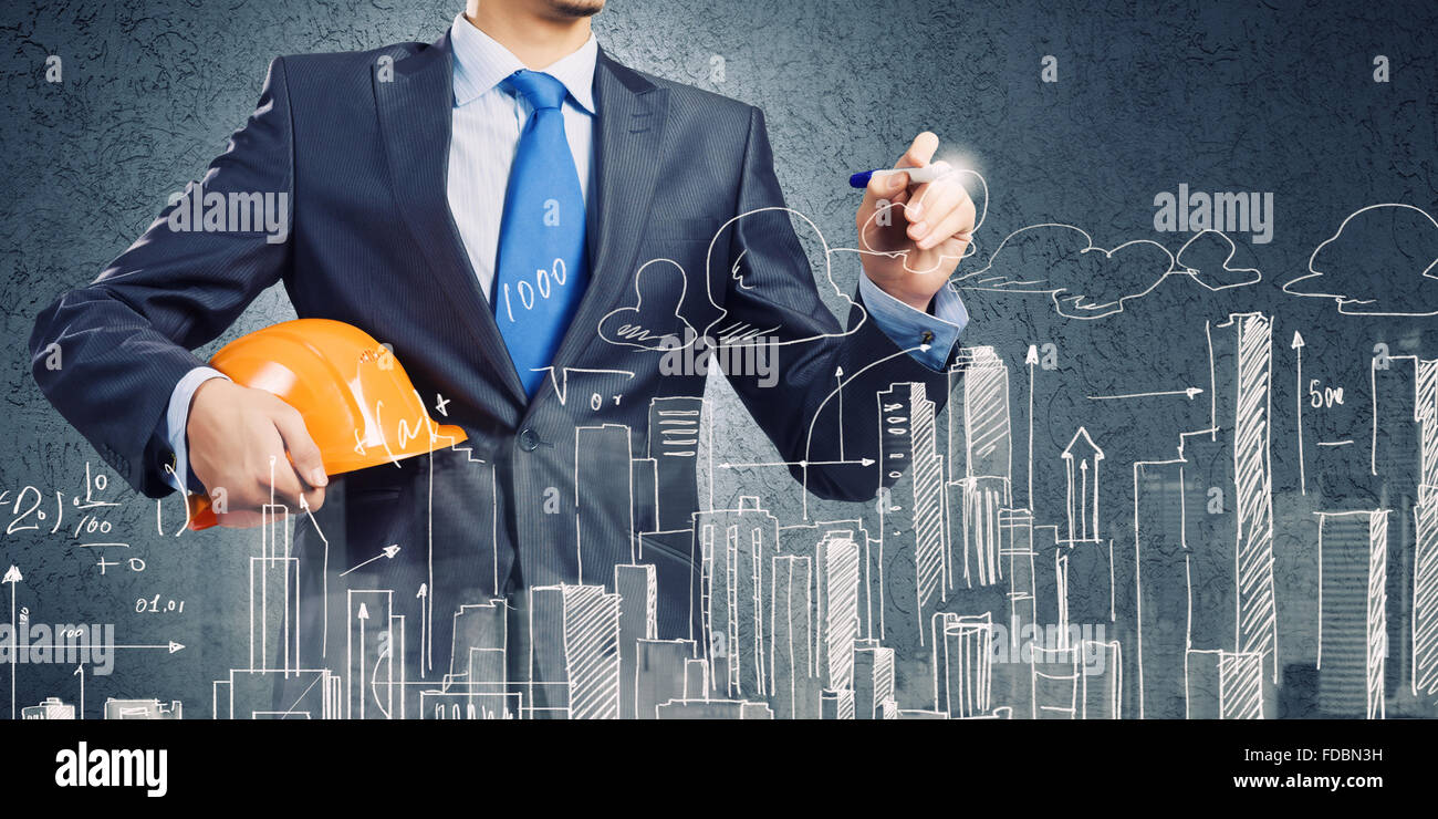 Young man engineer drawing sketches of construction project Stock Photo ...