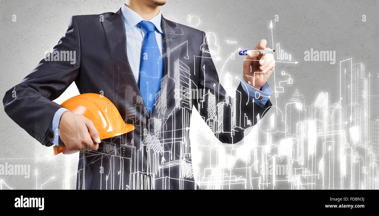 Young man engineer drawing sketches of construction project Stock Photo ...