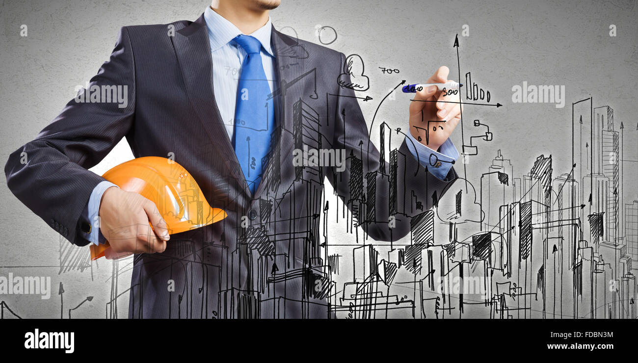 Young man engineer drawing sketches of construction project Stock Photo ...