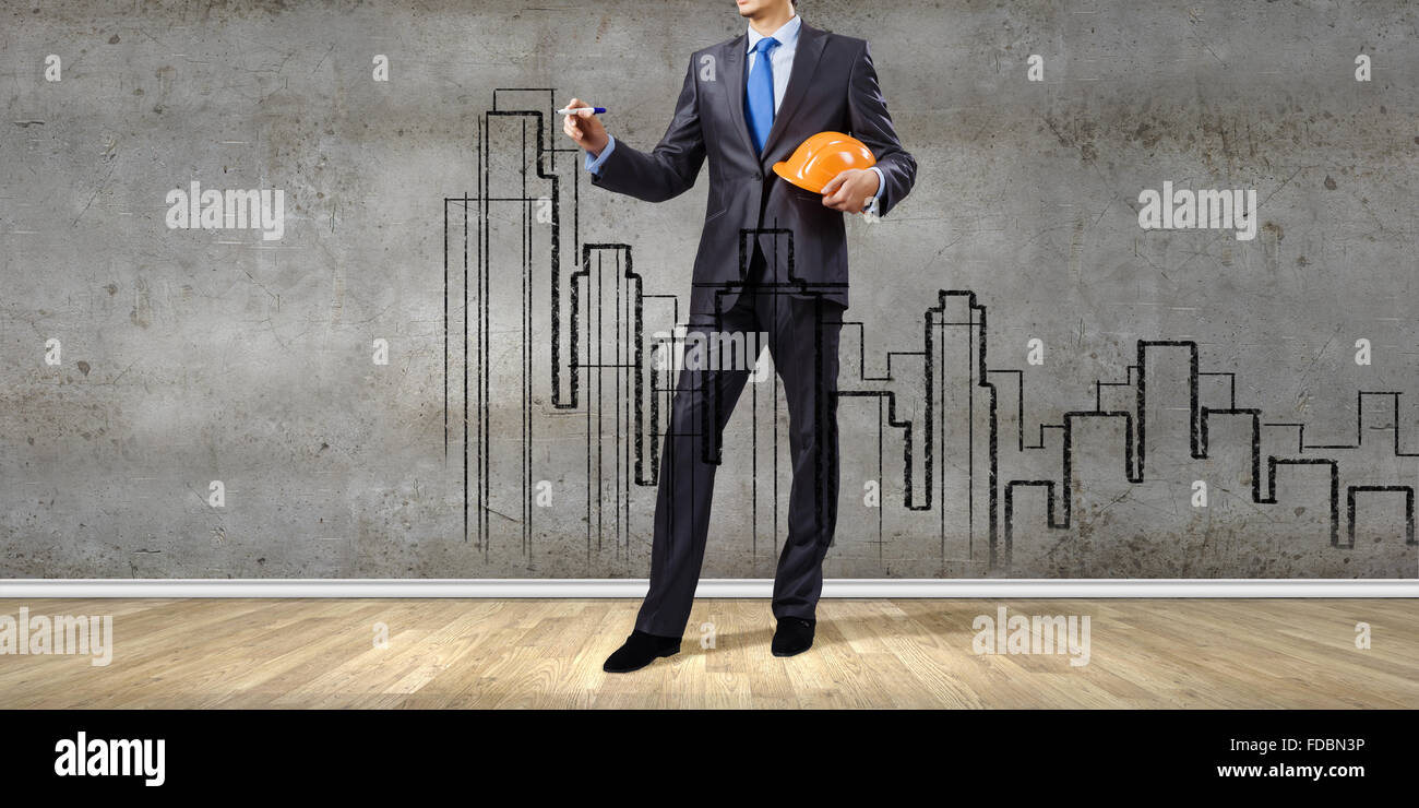 Young man engineer drawing sketches of construction project Stock Photo ...