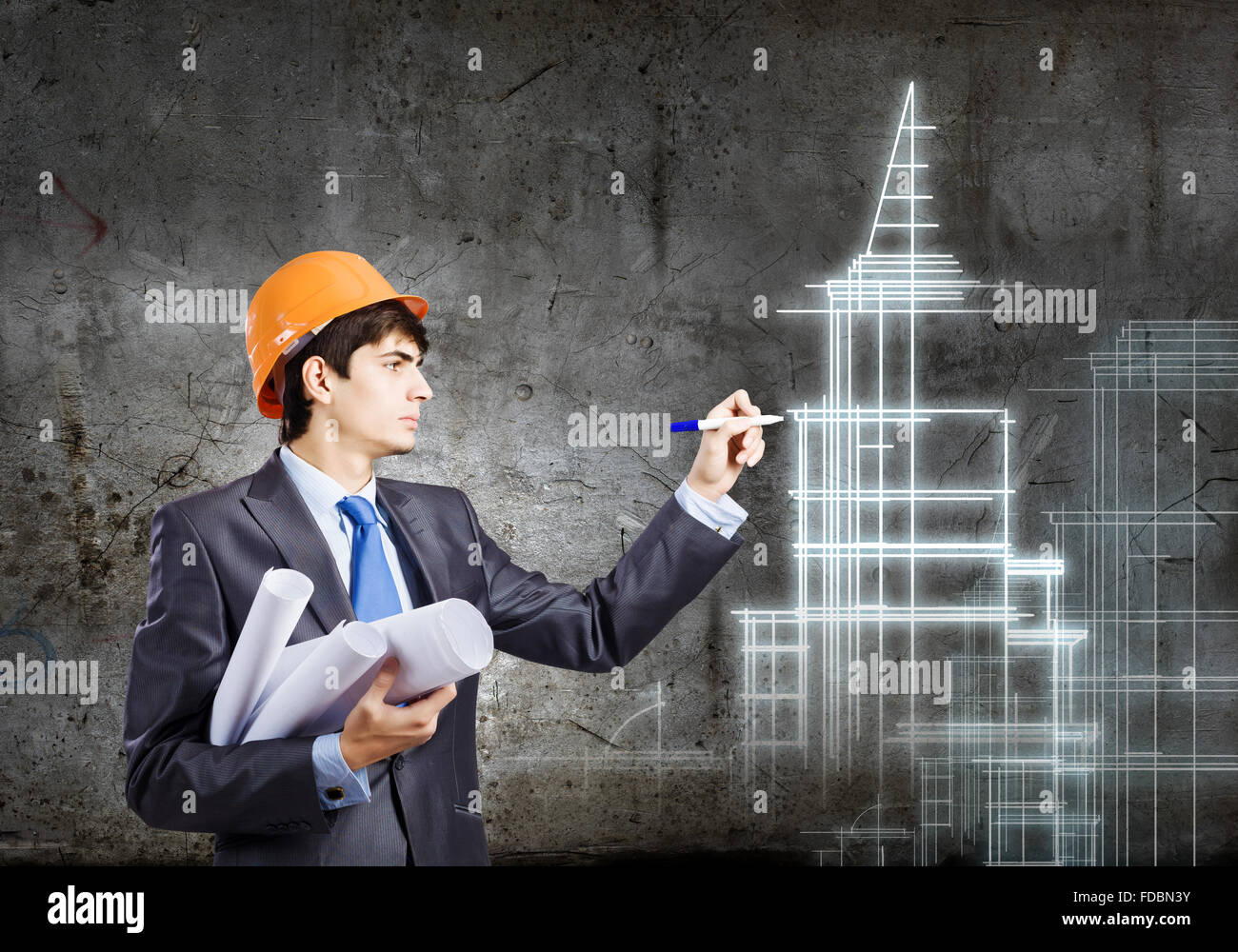 Young man engineer drawing sketches of construction project Stock Photo ...