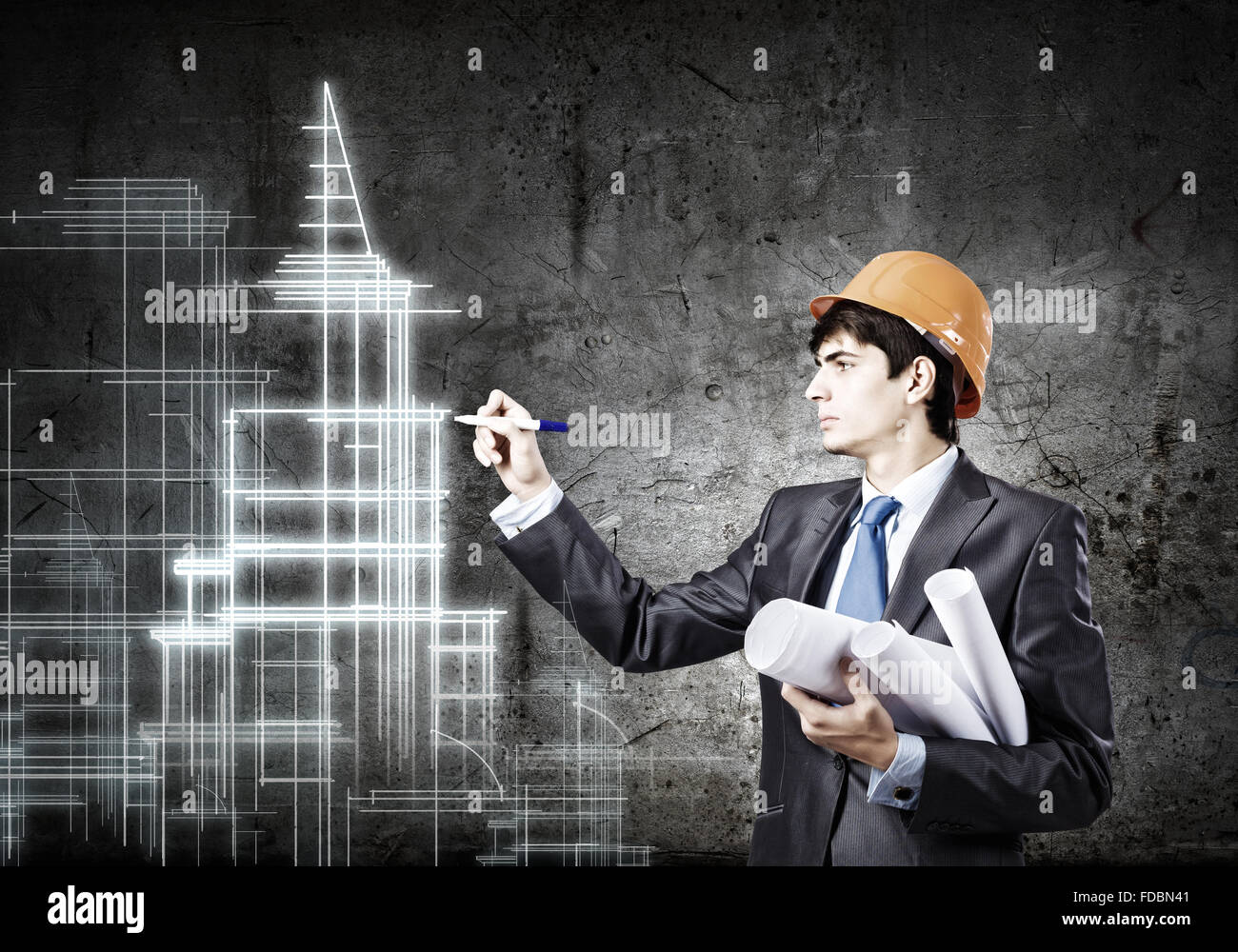 Young man engineer drawing sketches of construction project Stock Photo ...