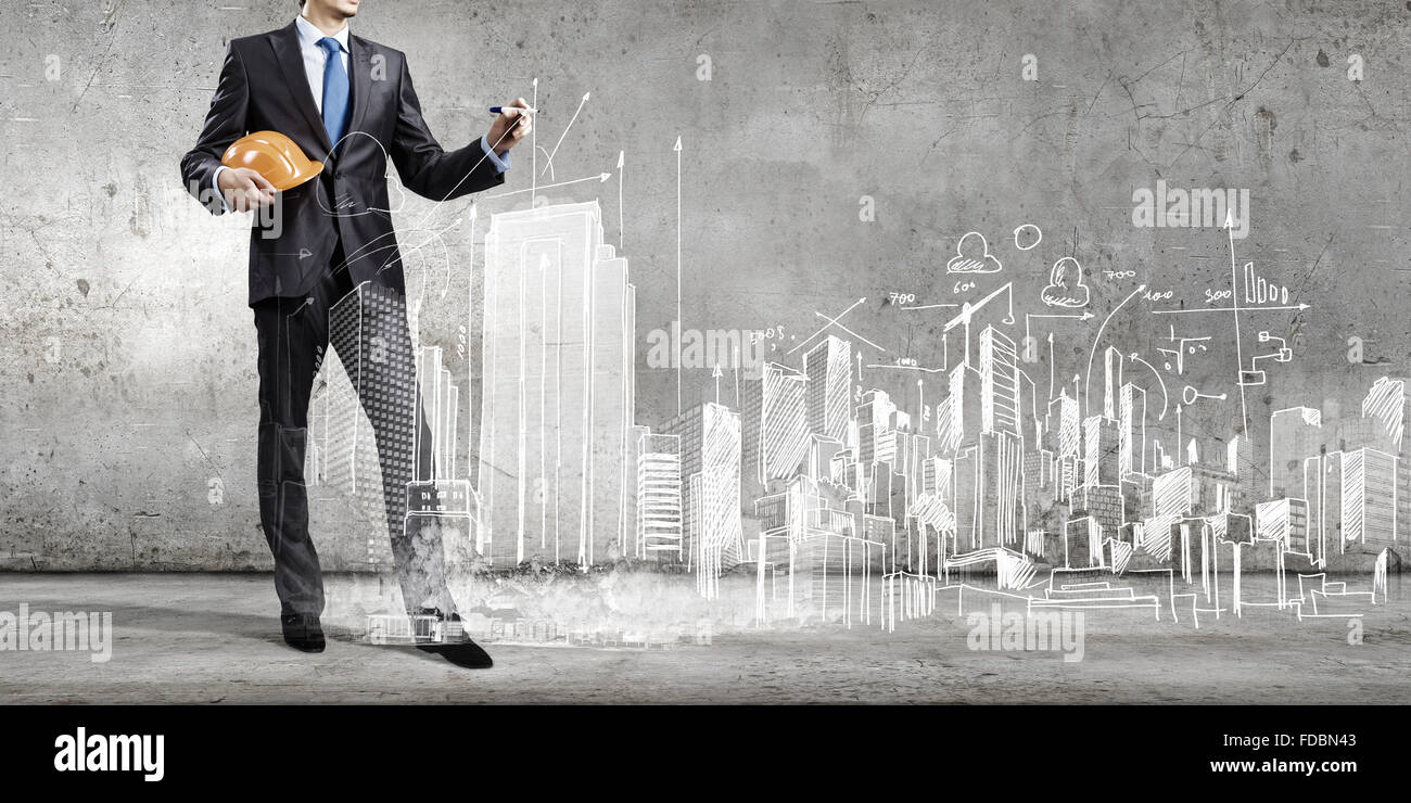 Young man engineer drawing sketches of construction project Stock Photo ...