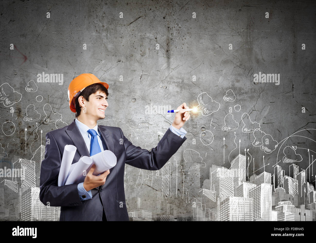 Young man engineer drawing sketches of construction project Stock Photo ...