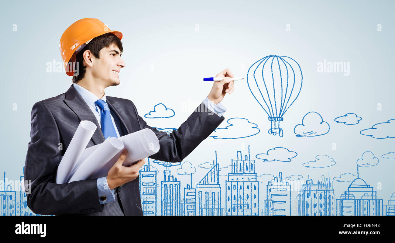 Young man engineer drawing sketches of construction project Stock Photo ...