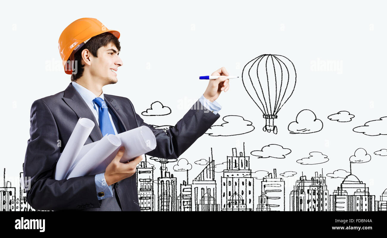 Young man engineer drawing sketches of construction project Stock Photo ...