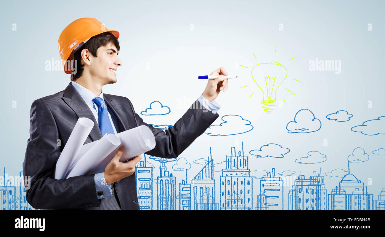 Young man engineer drawing sketches of construction project Stock Photo ...