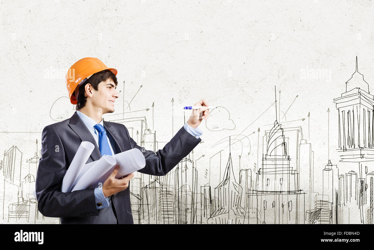 Young man engineer drawing sketches of construction project Stock Photo ...