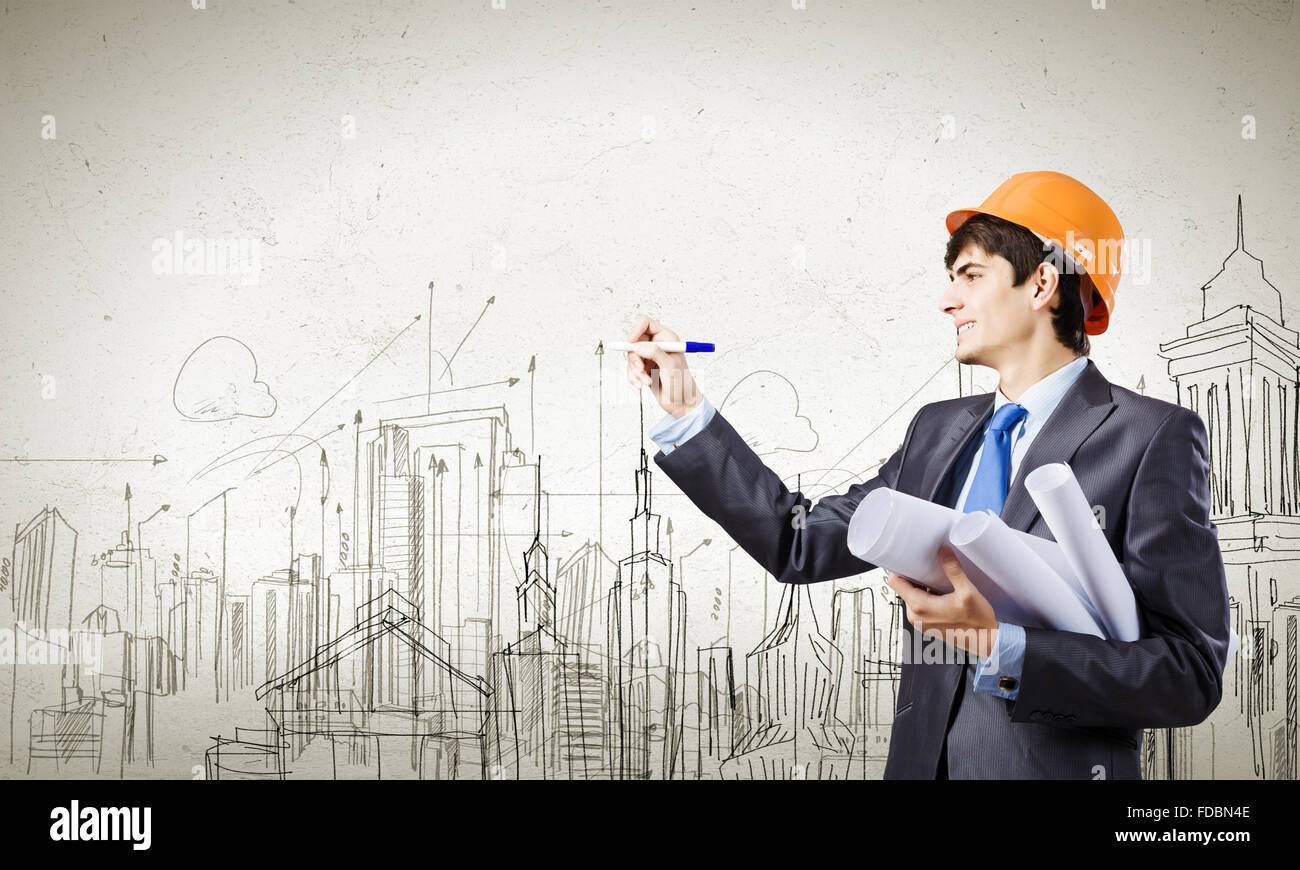 Young man engineer drawing sketches of construction project Stock Photo ...