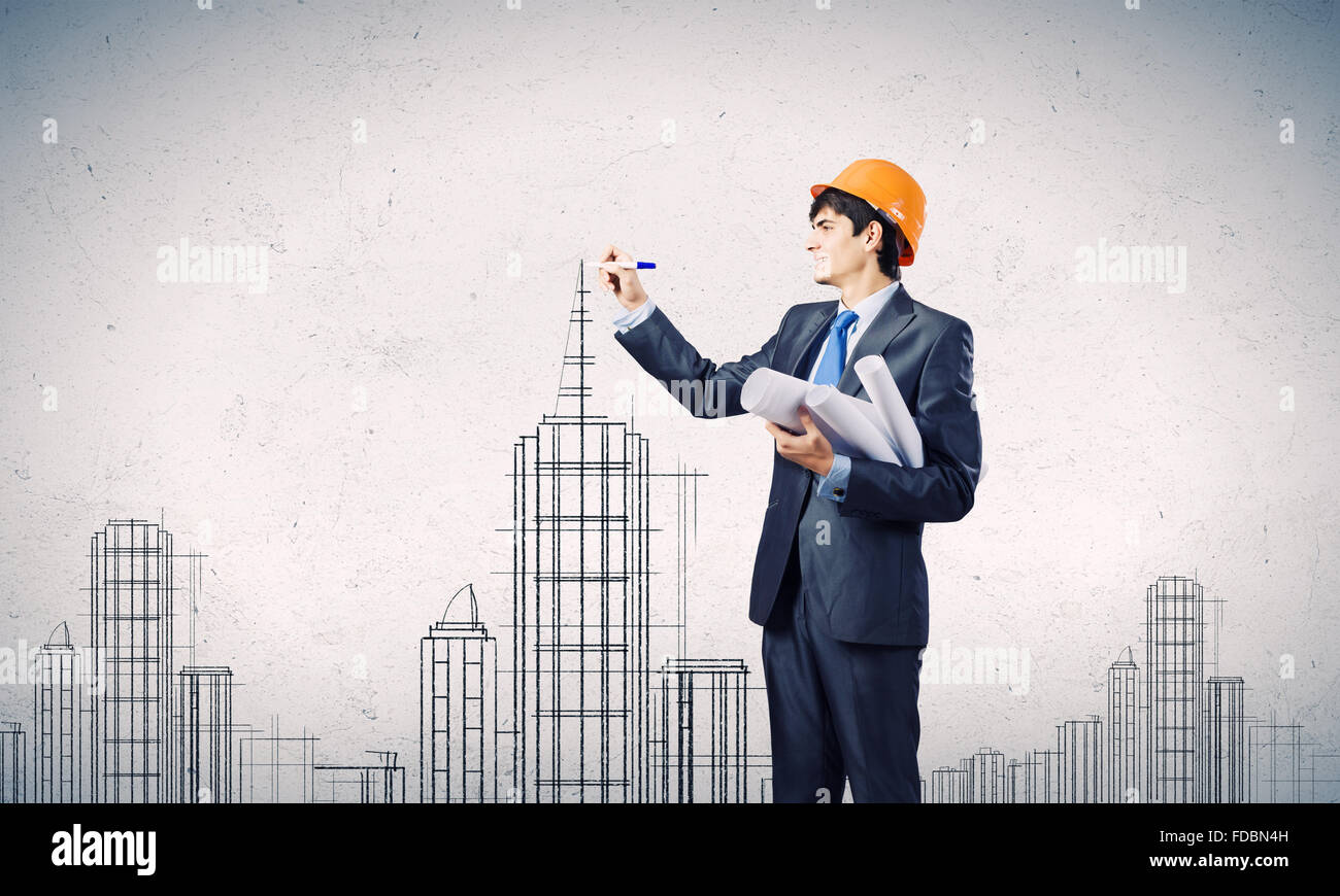 Young man engineer drawing sketches of construction project Stock Photo ...