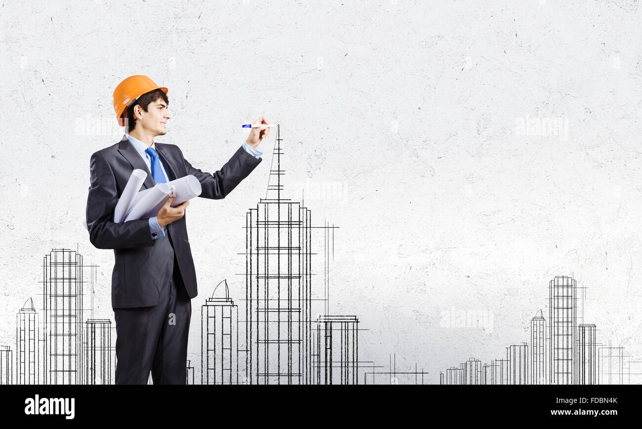 Young man engineer drawing sketches of construction project Stock Photo ...