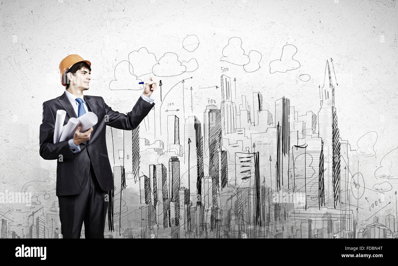 Young man engineer drawing sketches of construction project Stock Photo ...