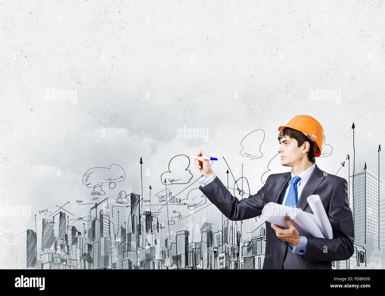 Young man engineer drawing sketches of construction project Stock Photo ...