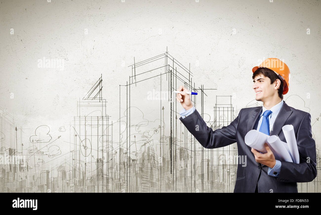 Young man engineer drawing sketches of construction project Stock Photo ...