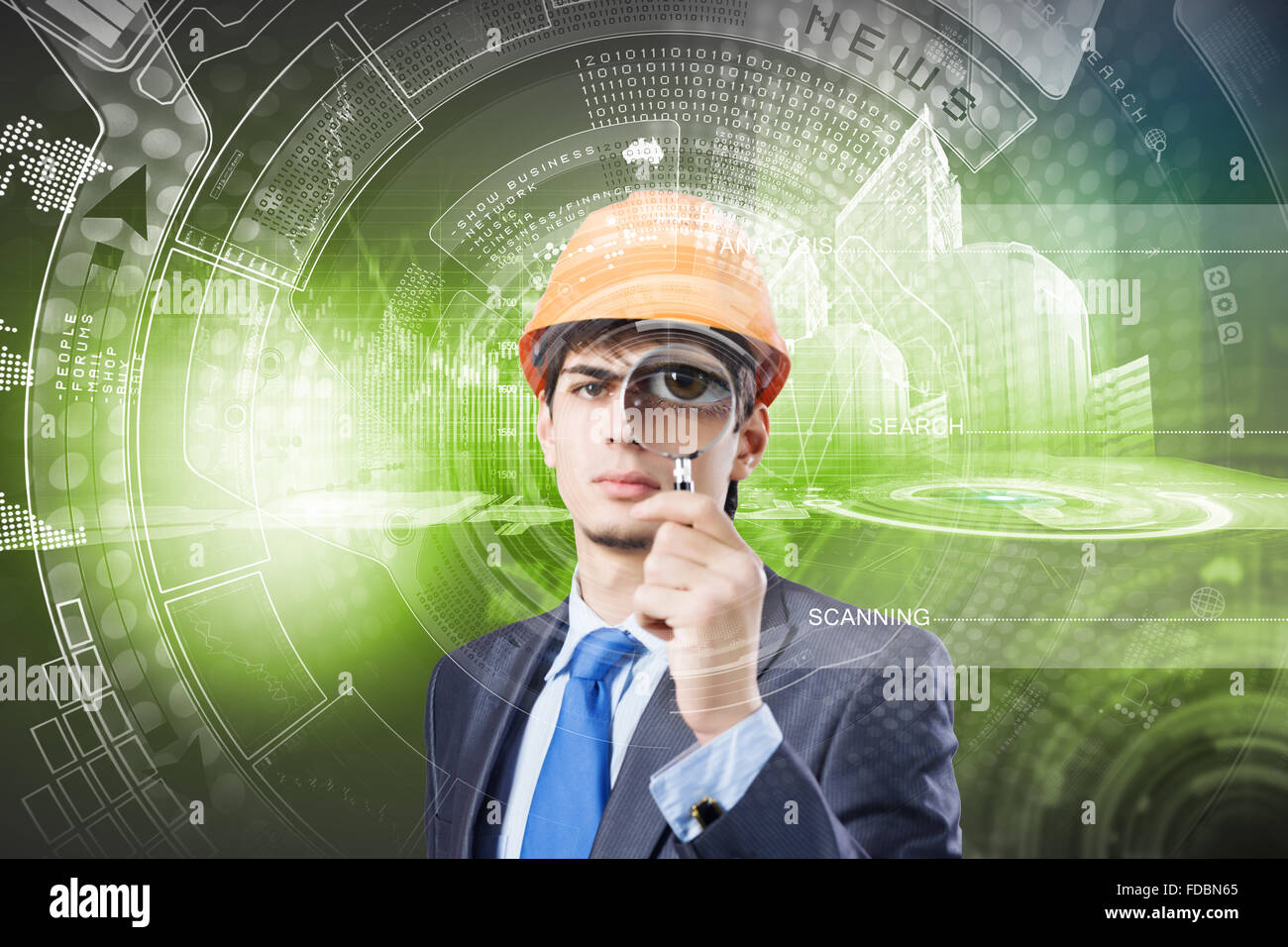 Young man engineer against media background looking in magnifying glass ...
