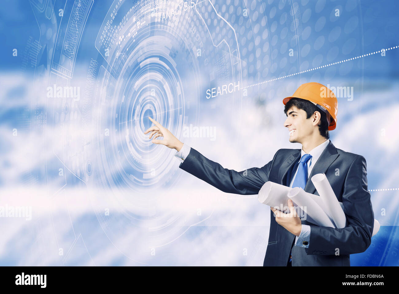 Young man engineer touching icon of media screen Stock Photo - Alamy