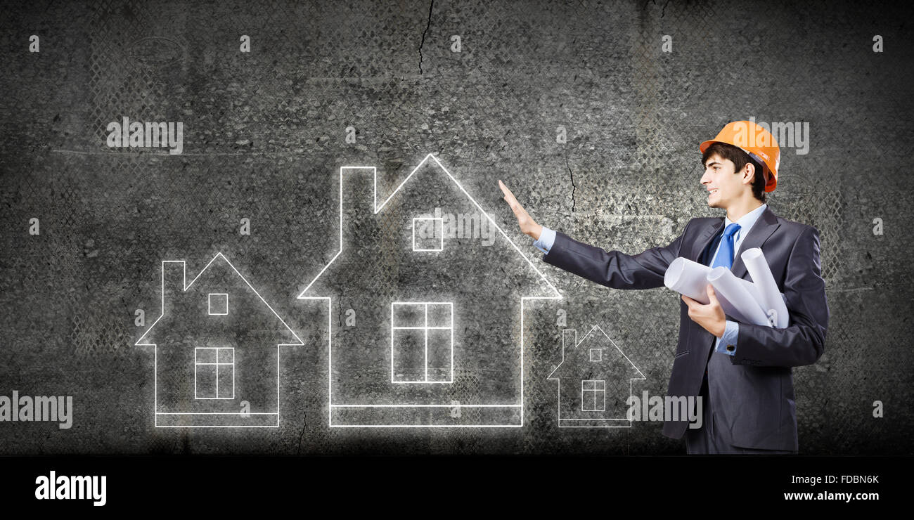 Young man engineer drawing sketches of construction project Stock Photo ...