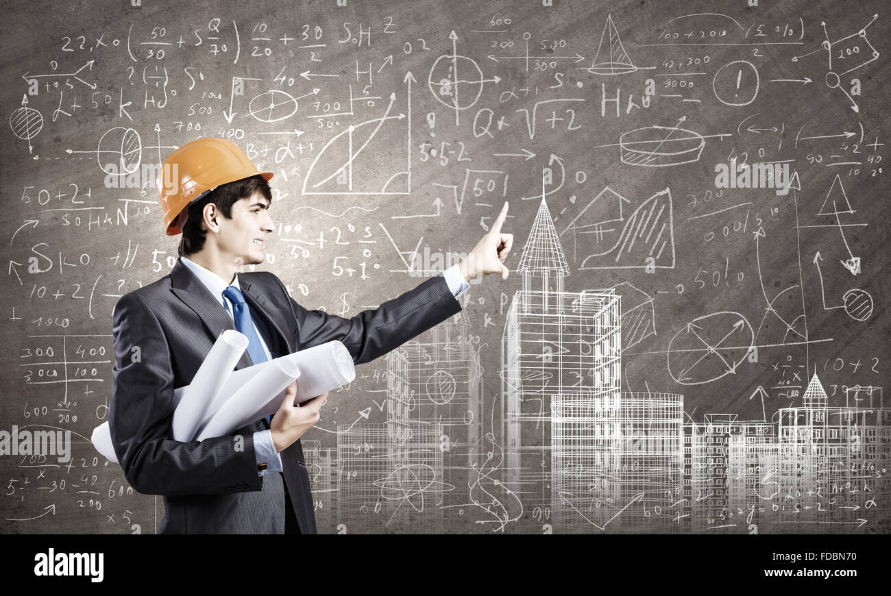 Young man engineer drawing sketches of construction project Stock Photo ...
