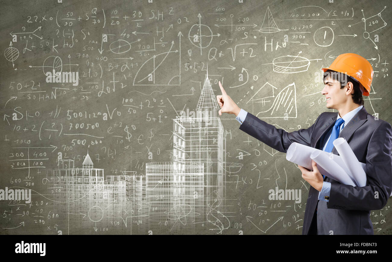 Young man engineer drawing sketches of construction project Stock Photo ...