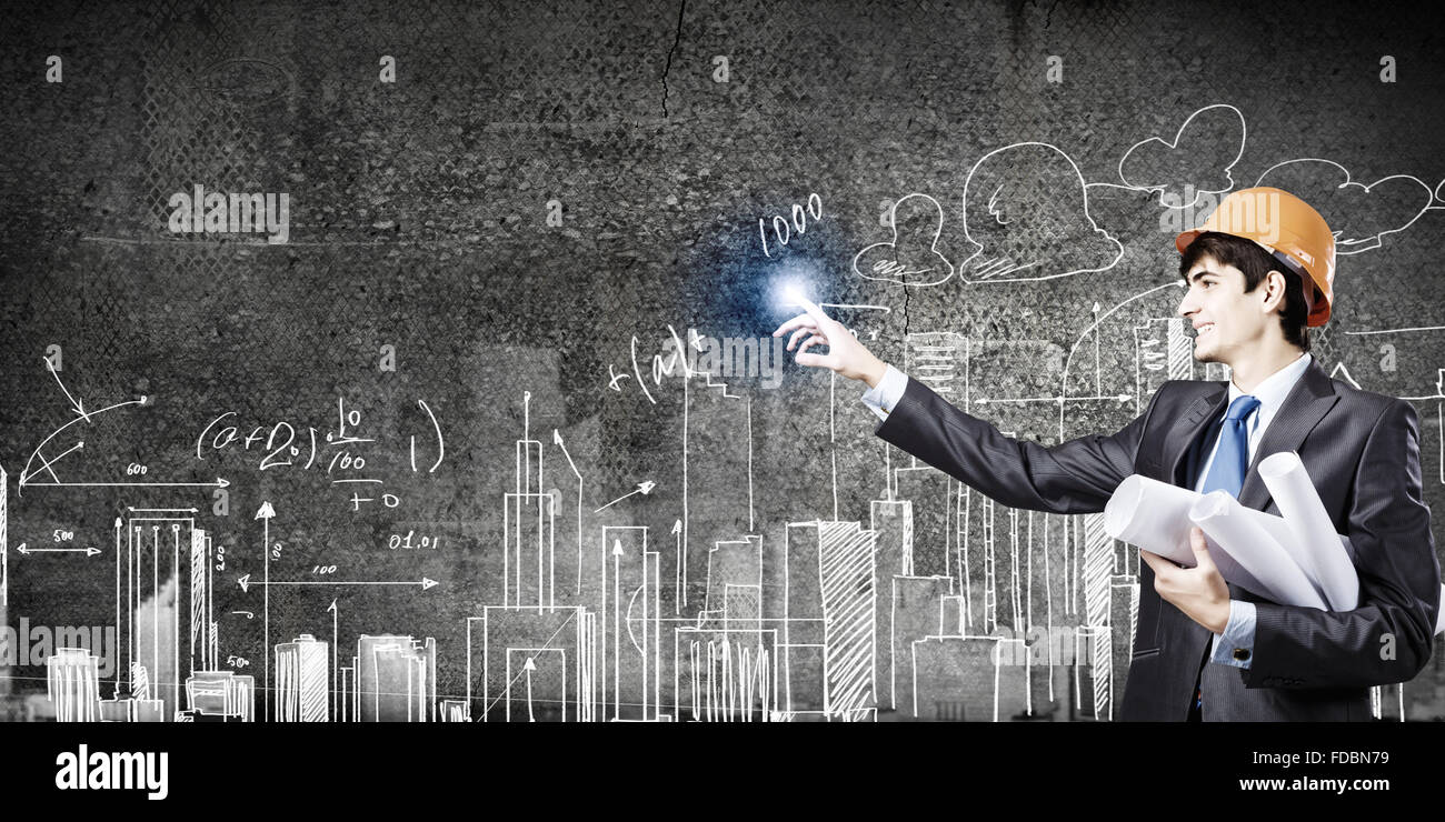 Young man engineer drawing sketches of construction project Stock Photo ...