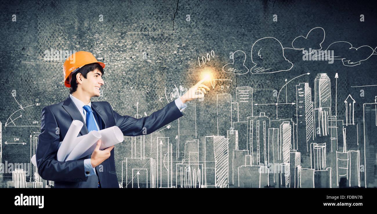 Young man engineer drawing sketches of construction project Stock Photo ...