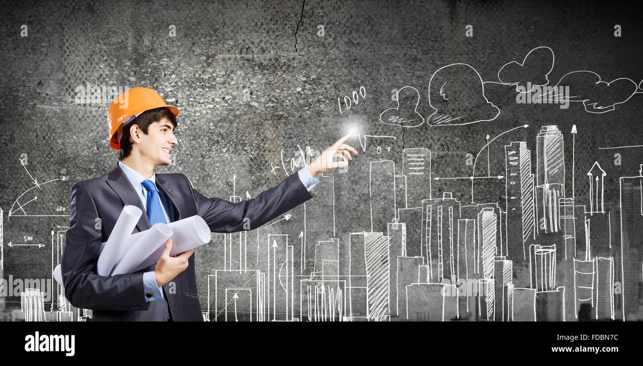 Young man engineer drawing sketches of construction project Stock Photo ...