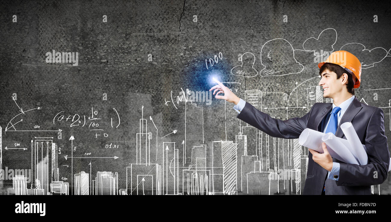 Young man engineer drawing sketches of construction project Stock Photo ...