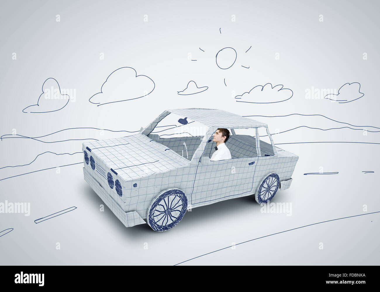 Young man driving car made of sheet of paper Stock Photo - Alamy