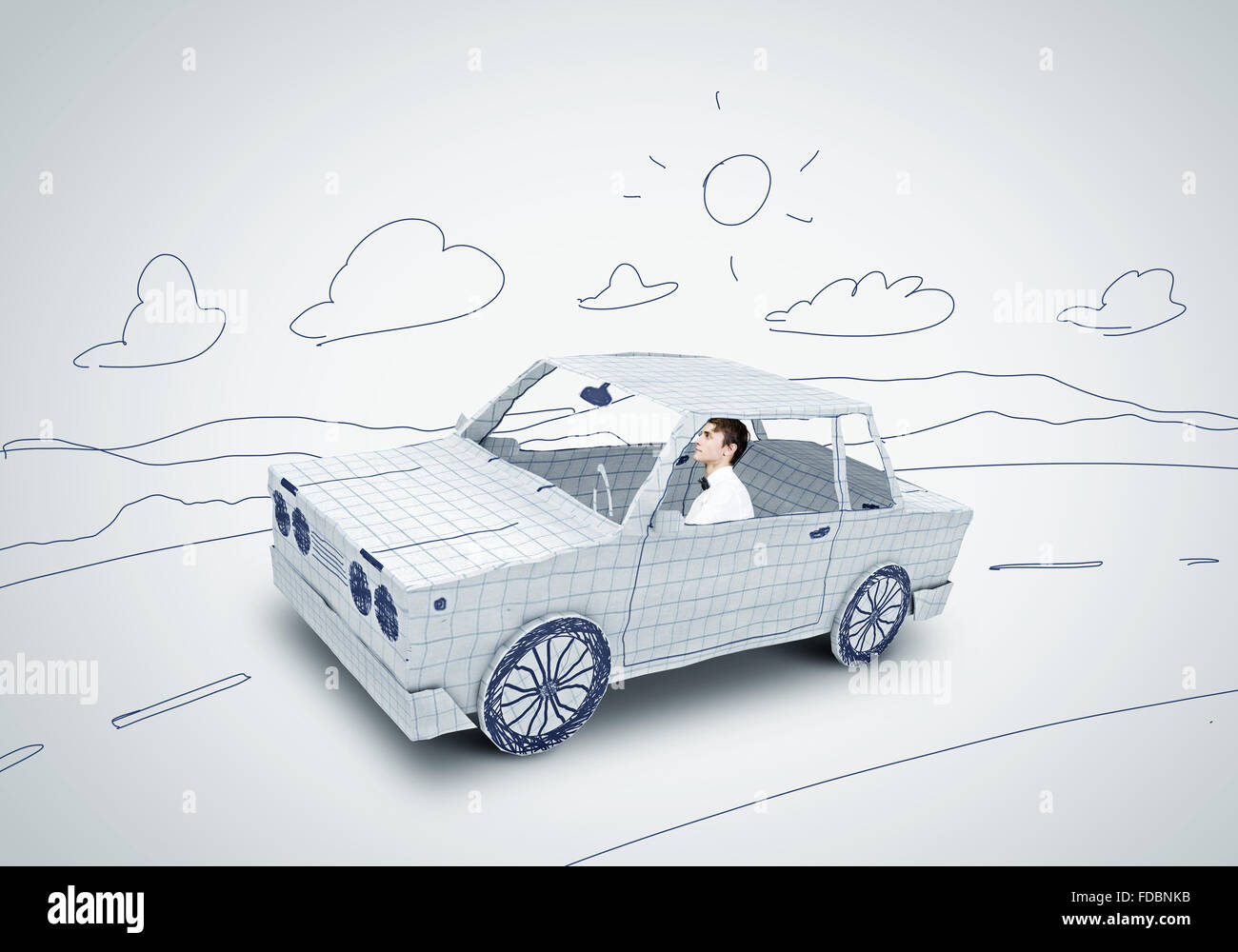Young man driving car made of sheet of paper Stock Photo - Alamy