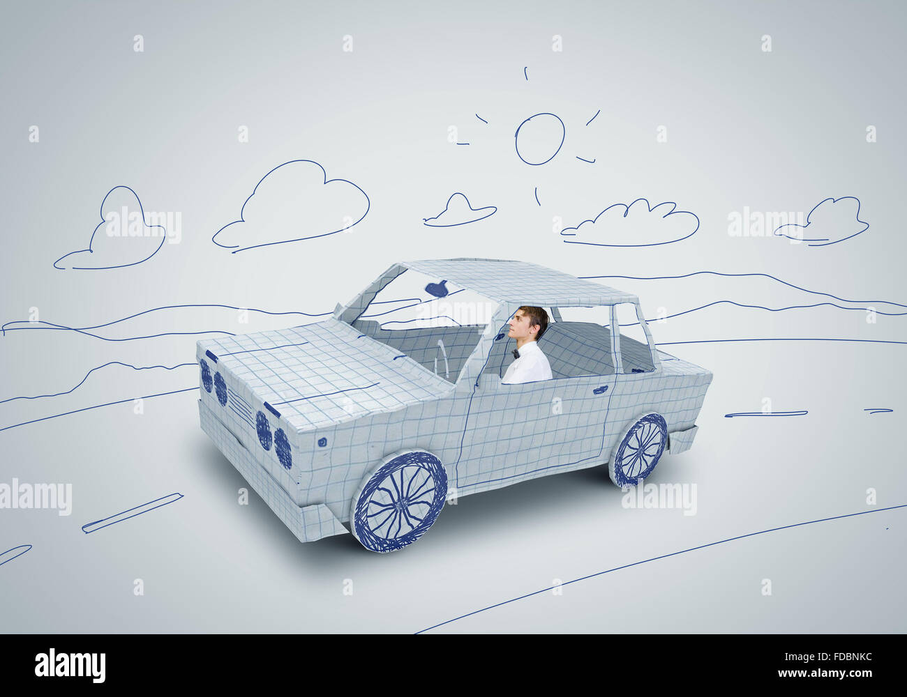 Young man driving car made of sheet of paper Stock Photo - Alamy