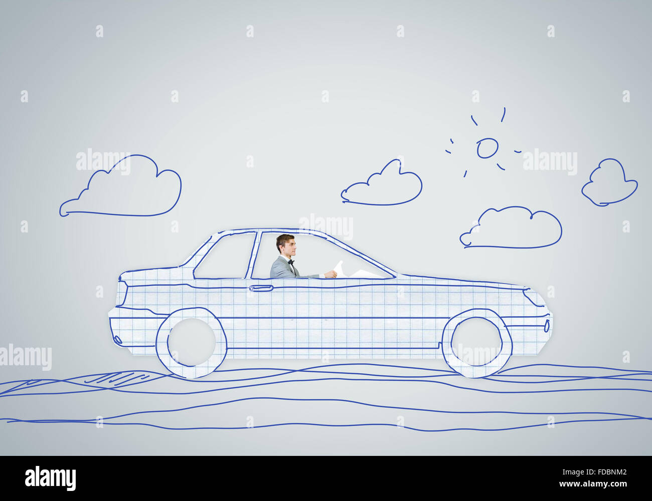 Young man driving car made of sheet of paper Stock Photo - Alamy