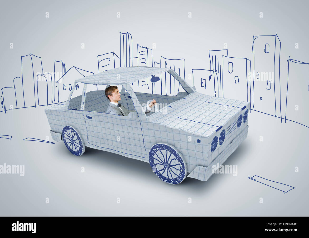 Young man driving car made of sheet of paper Stock Photo - Alamy