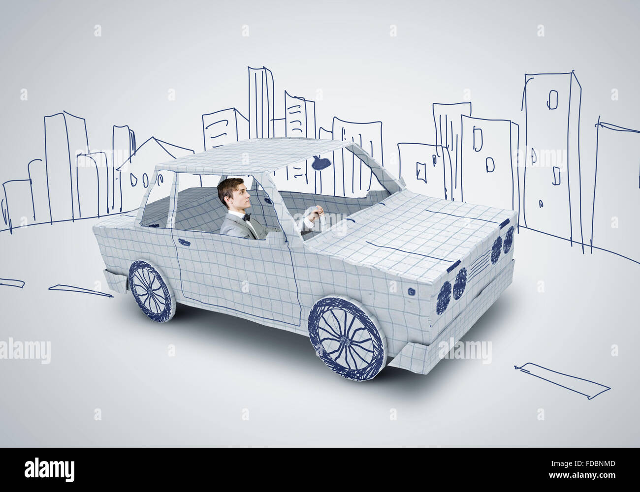 Young man driving car made of sheet of paper Stock Photo - Alamy
