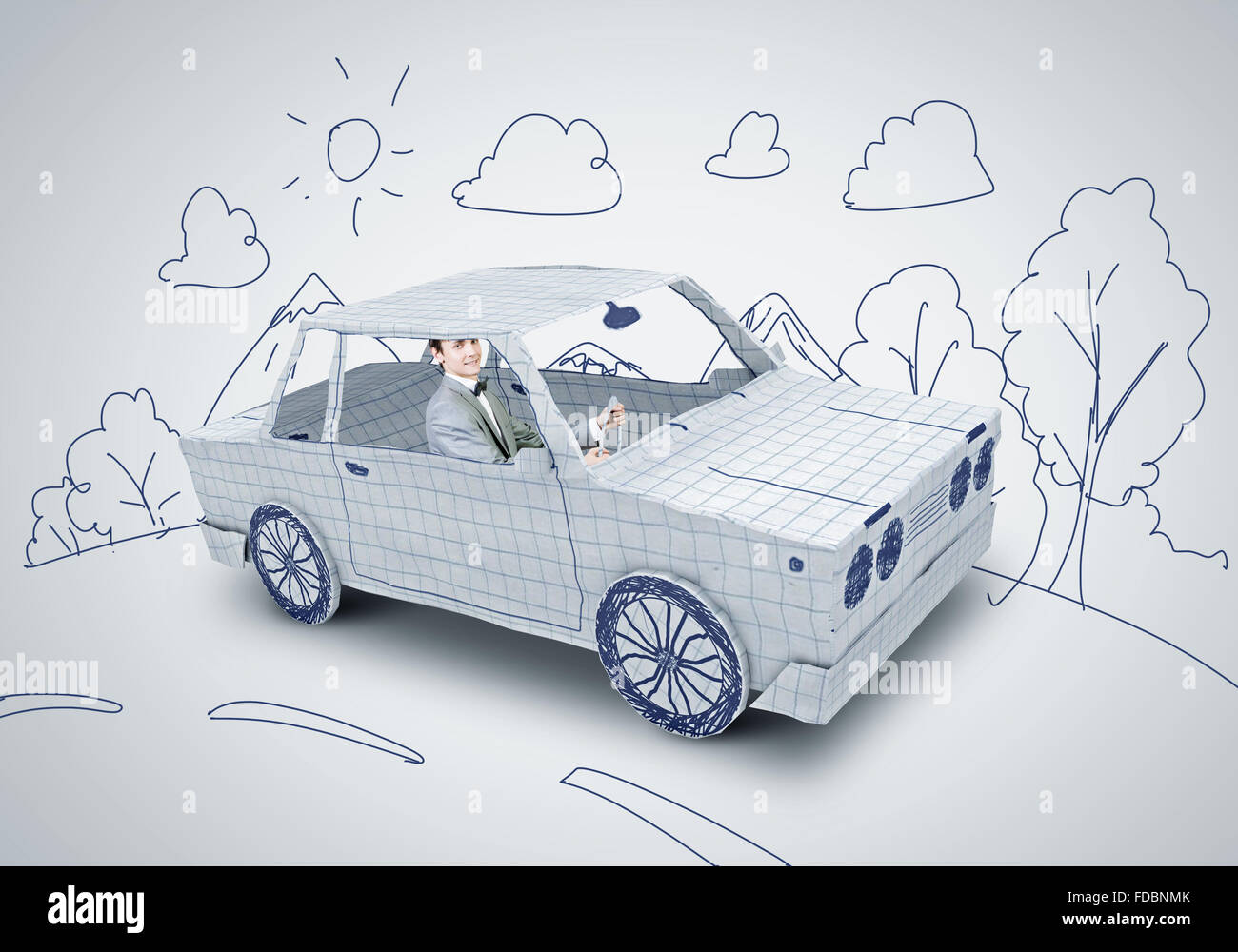 Young man driving car made of sheet of paper Stock Photo - Alamy