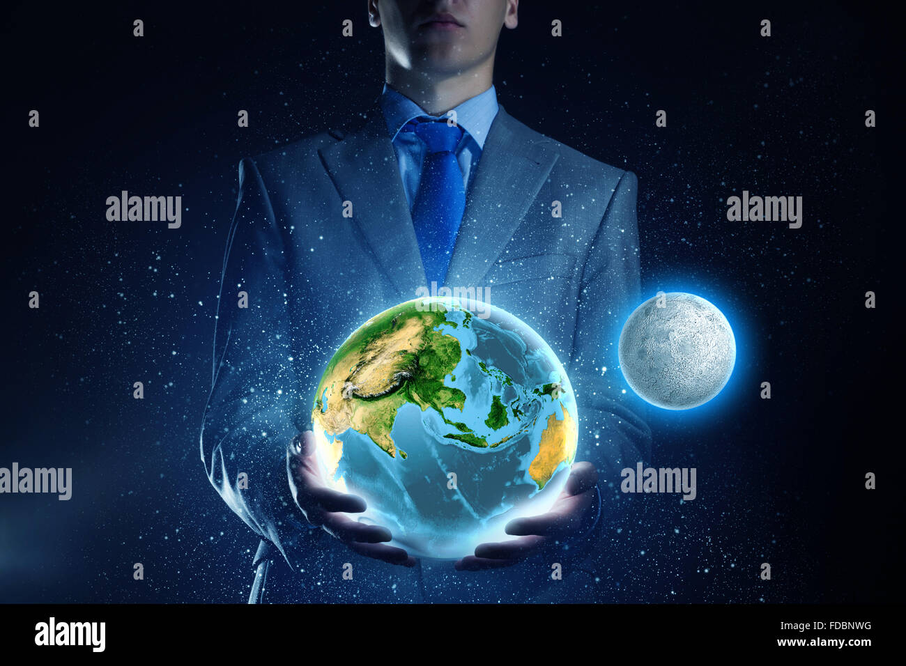 Young businessman holding Earth planet in hand. Elements of this image ...