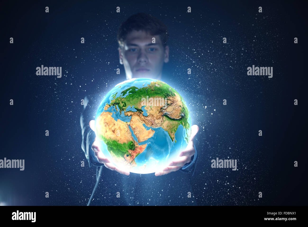 Young businessman holding Earth planet in hand. Elements of this image ...