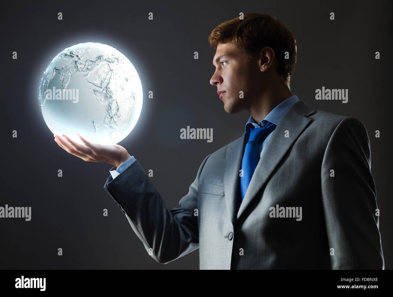 Young businessman holding moon planet in hand Stock Photo - Alamy